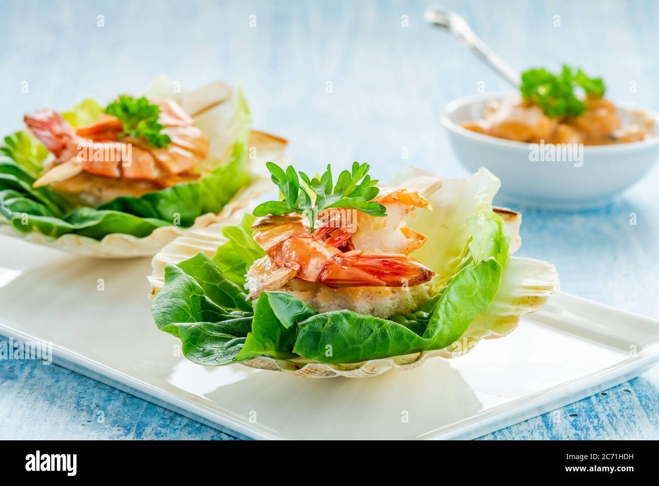 Canapes with grilled black tiger prawns and seafood sauce on fresh ...