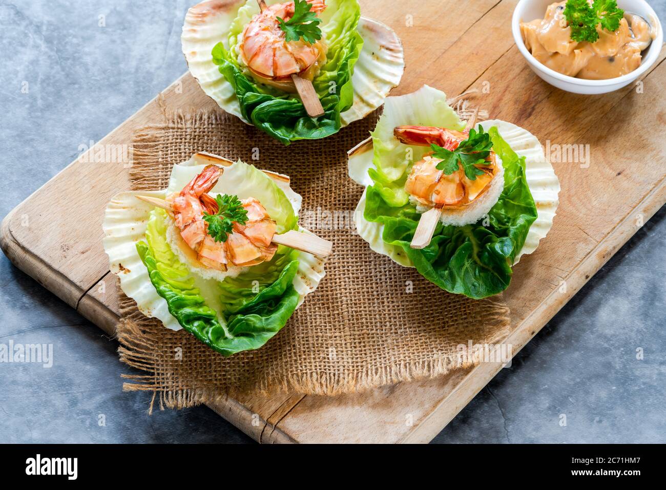Canapes with grilled black tiger prawns and seafood sauce on fresh ...
