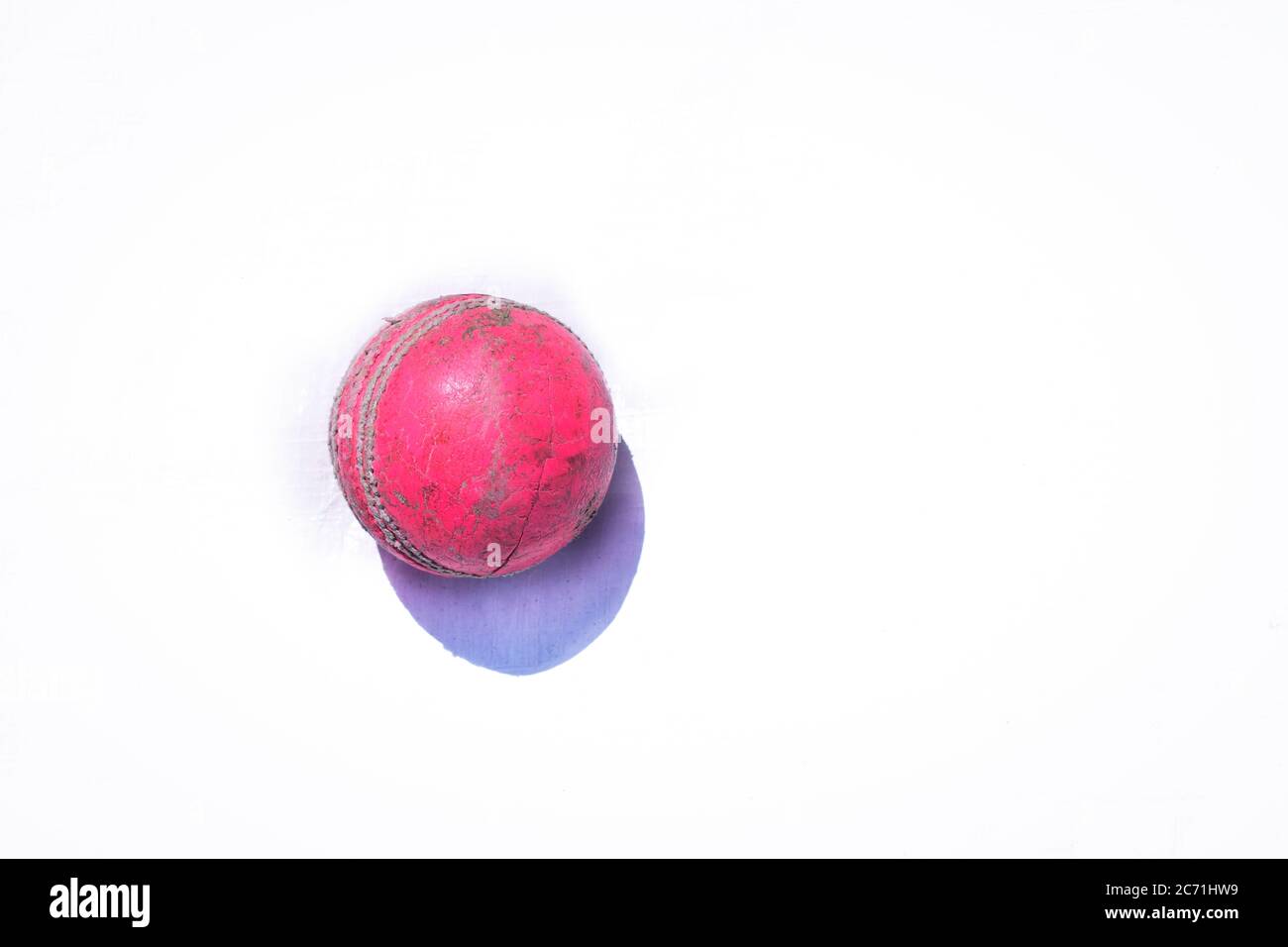 Pink cricket ball isolated on a white background Stock Photo - Alamy