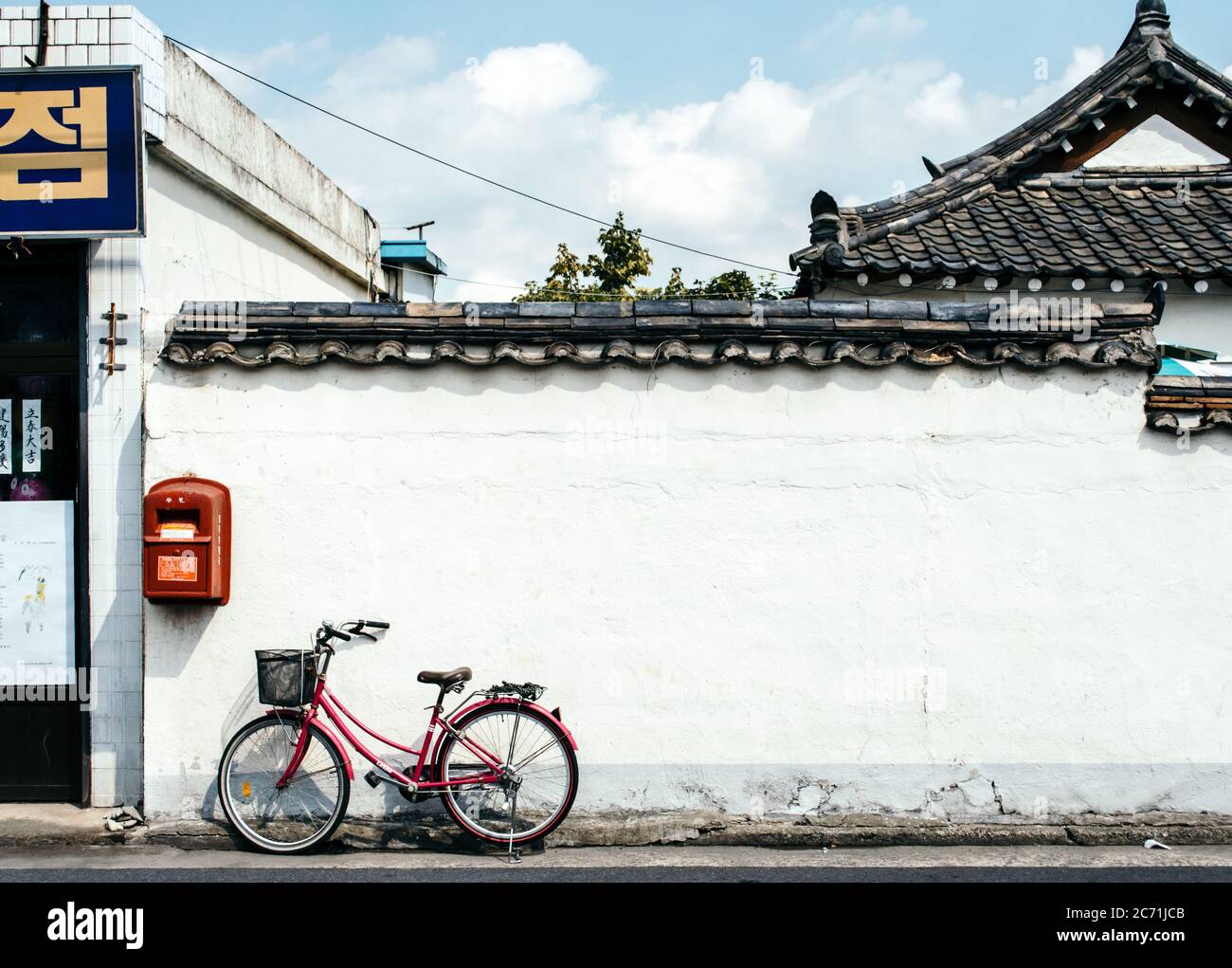 Gyeongju, South Korea - Red postbox and red bicycle and white wall with ...