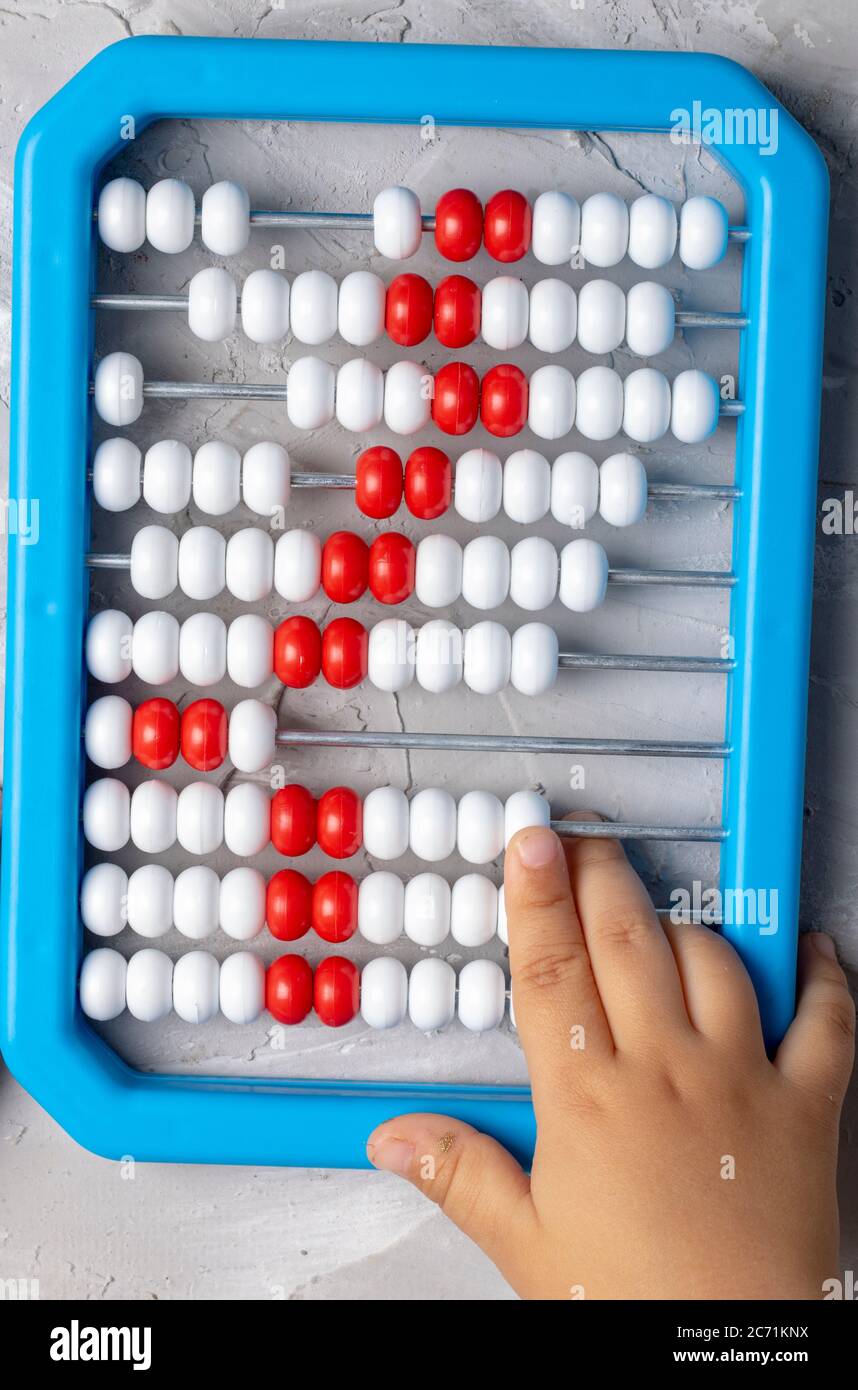 Asian kid's hand playing abacus, top view. Vertical photo Stock Photo ...