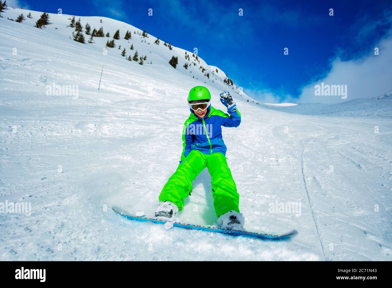 Cute little boy on snowboard stop after moving fast before camera Stock ...