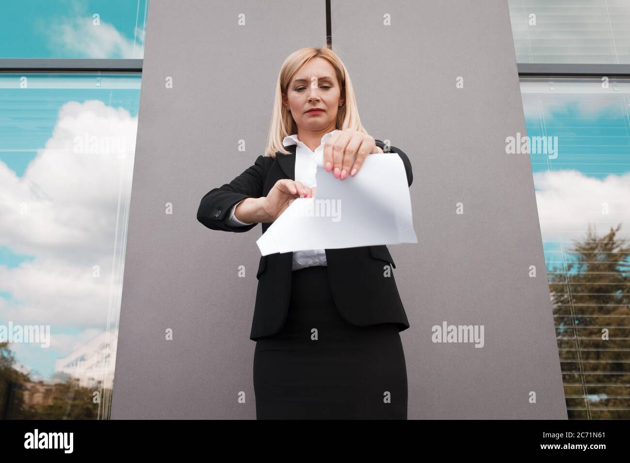 Female secretary tearing paper document Stock Photo - Alamy