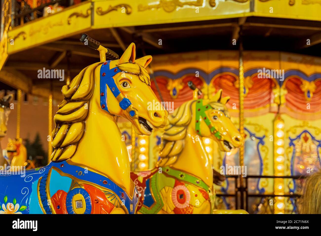 Colourful fairground carousel with bright colorful Horses closeup ...