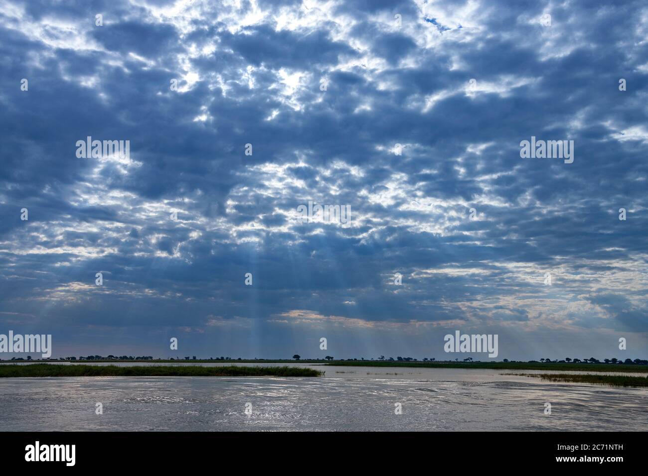 Sun rays over the Chobe River in Chobe National Park in northern ...