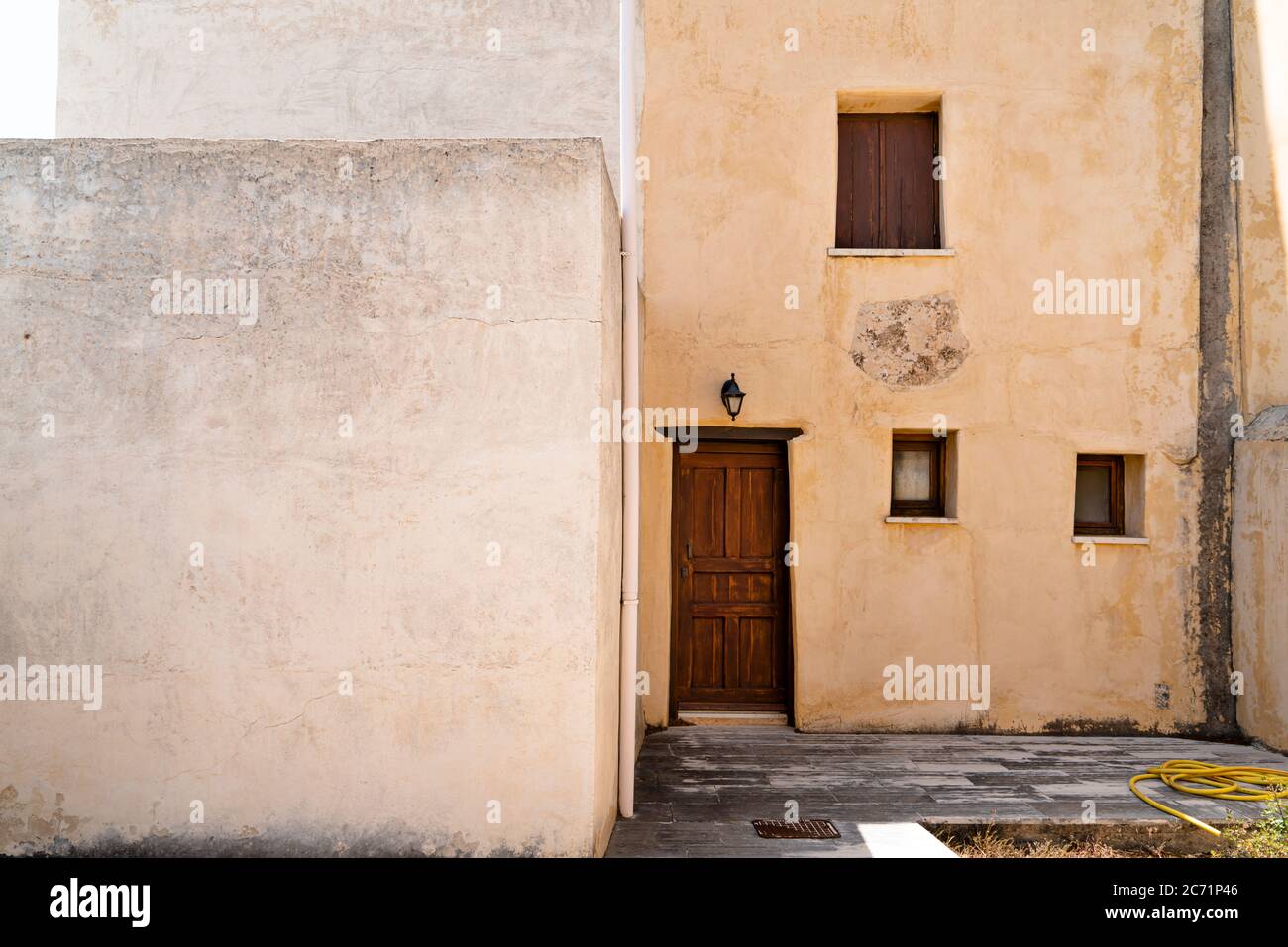 Old yellow house with wooden doors and windows in Greece Stock Photo ...