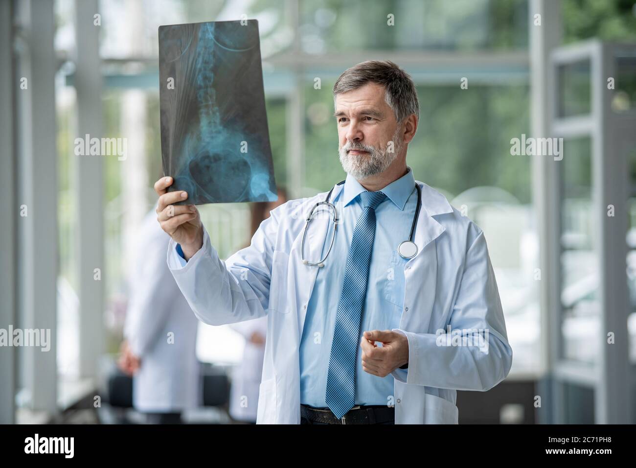 Doctor checking xray senior hi-res stock photography and images - Alamy