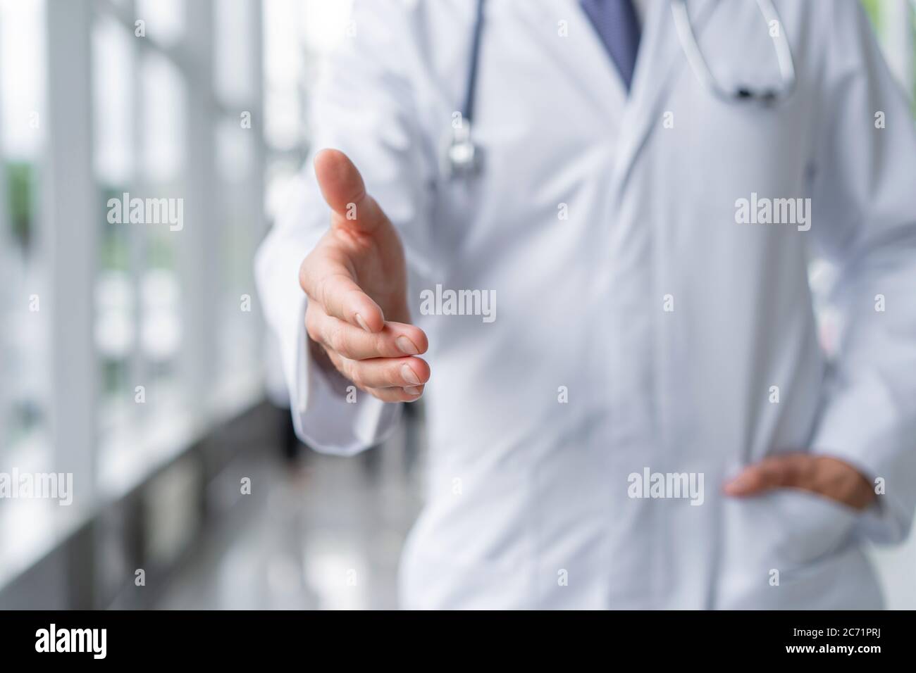 young doctor welcoming at his office. medical doctor man smile, hold ...