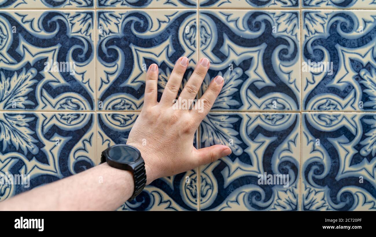 Lisbon, Portugal - July 2017: Hand touching traditional ceramic ...