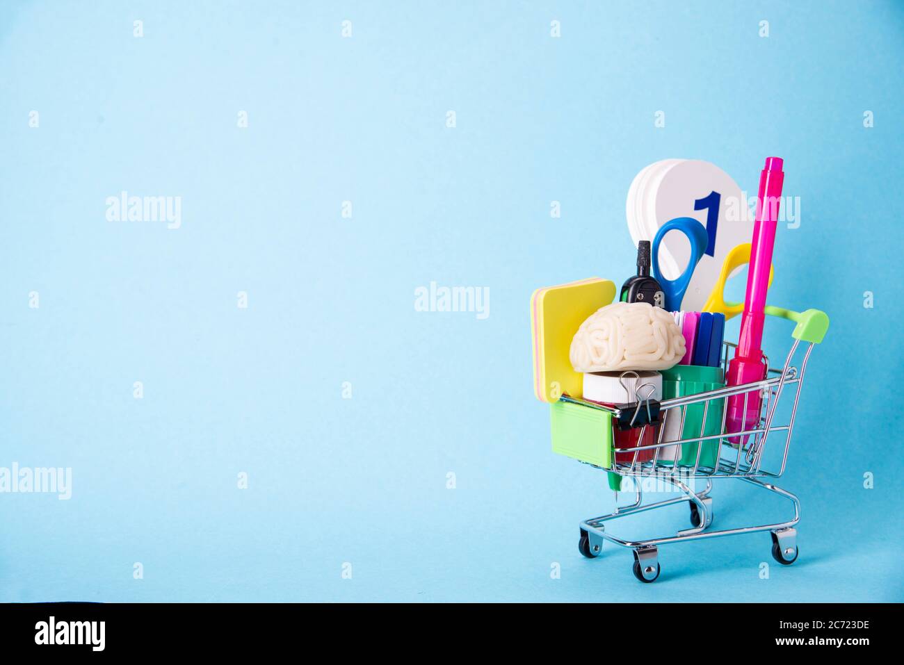 Concept of back to school. Shopping cart with school supplies Stock ...