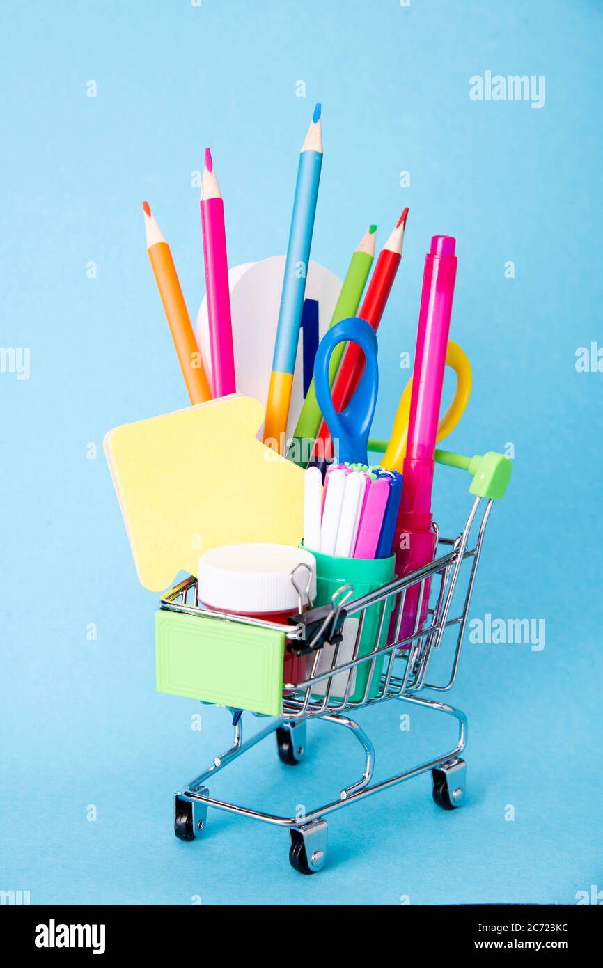 Concept of back to school. Shopping cart with school supplies Stock ...