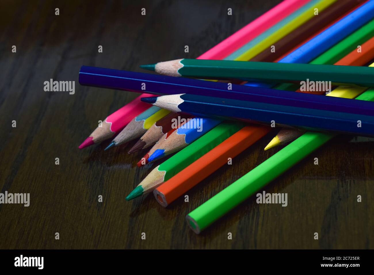 Pile of different colored wood pencil crayons placed in top of one ...