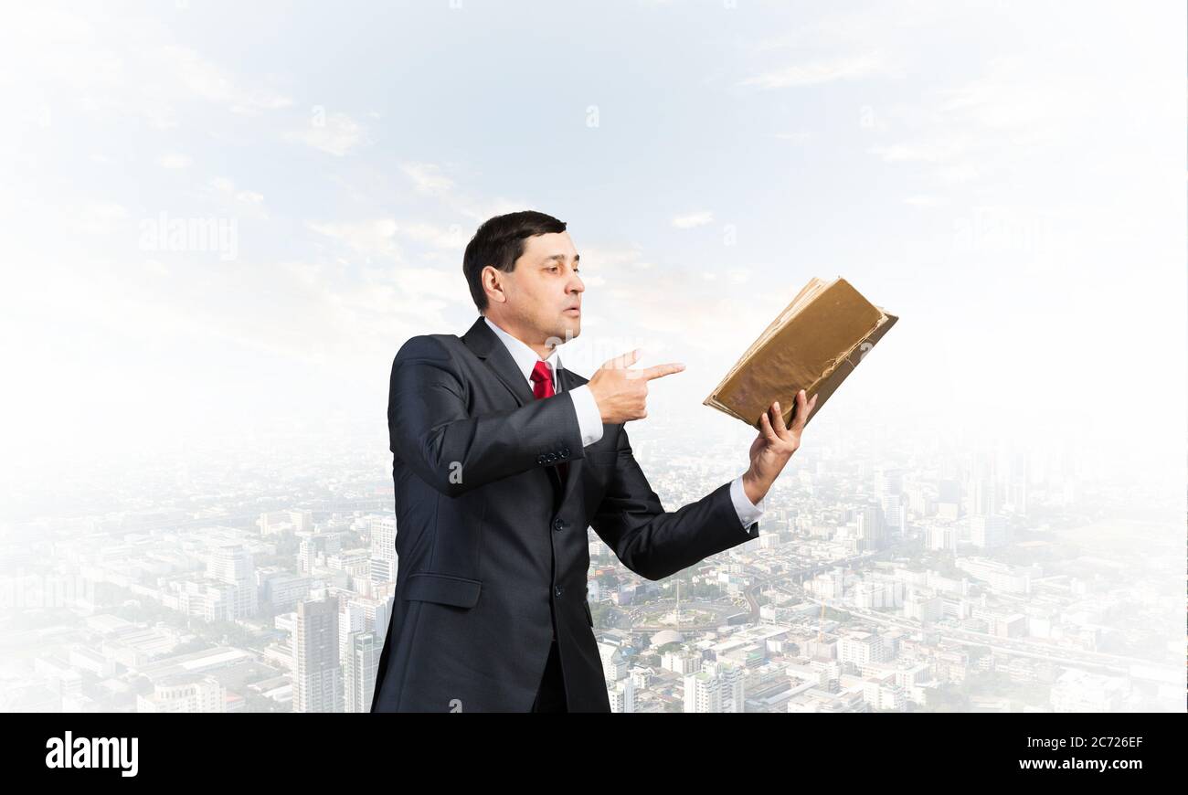 Man pointing open book hi-res stock photography and images - Alamy