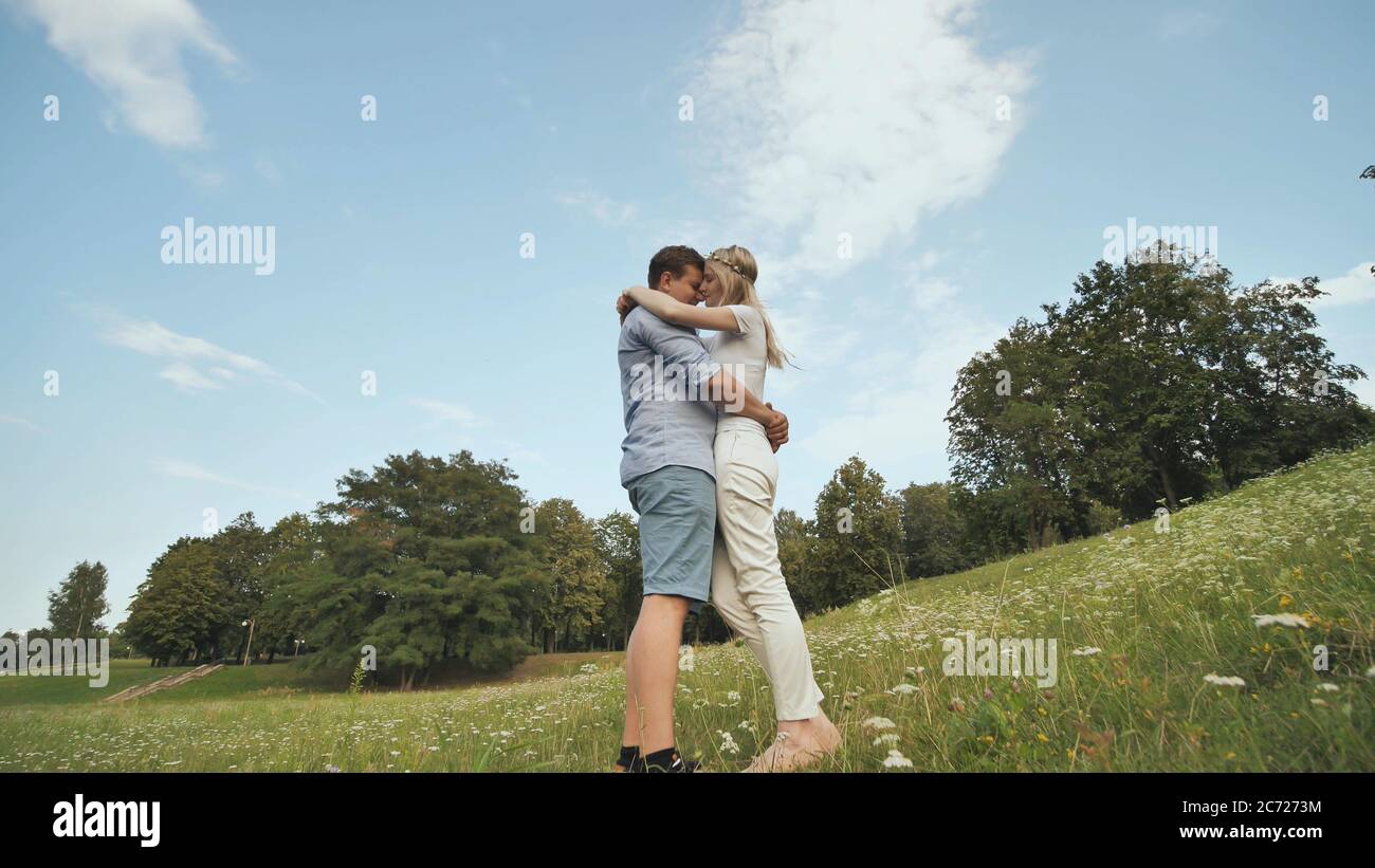 A young man and woman are standing in parks hugging each other. Video ...