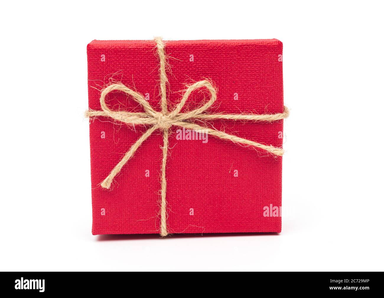 Red gift box tied with a rope tied into a bow isolated on a white ...