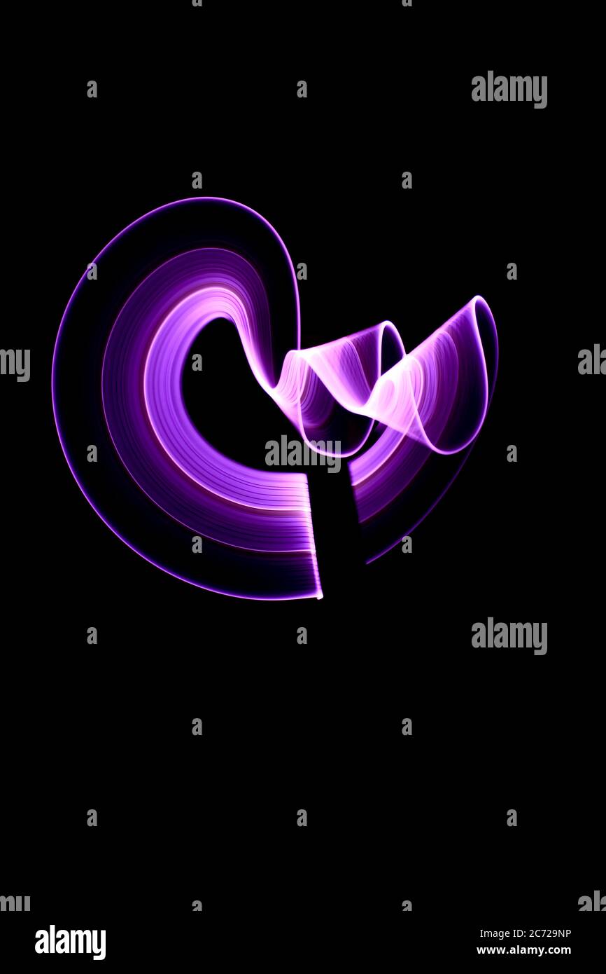 Curved abstract shape made with a light saber violet. Lightpainting ...