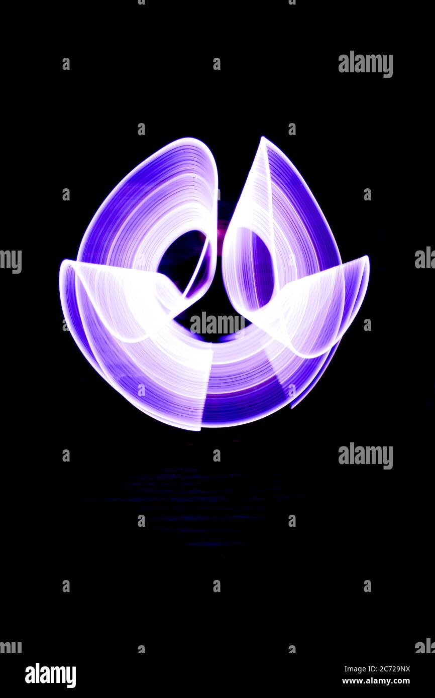Curved abstract shape made with a light saber violet. Lightpainting ...