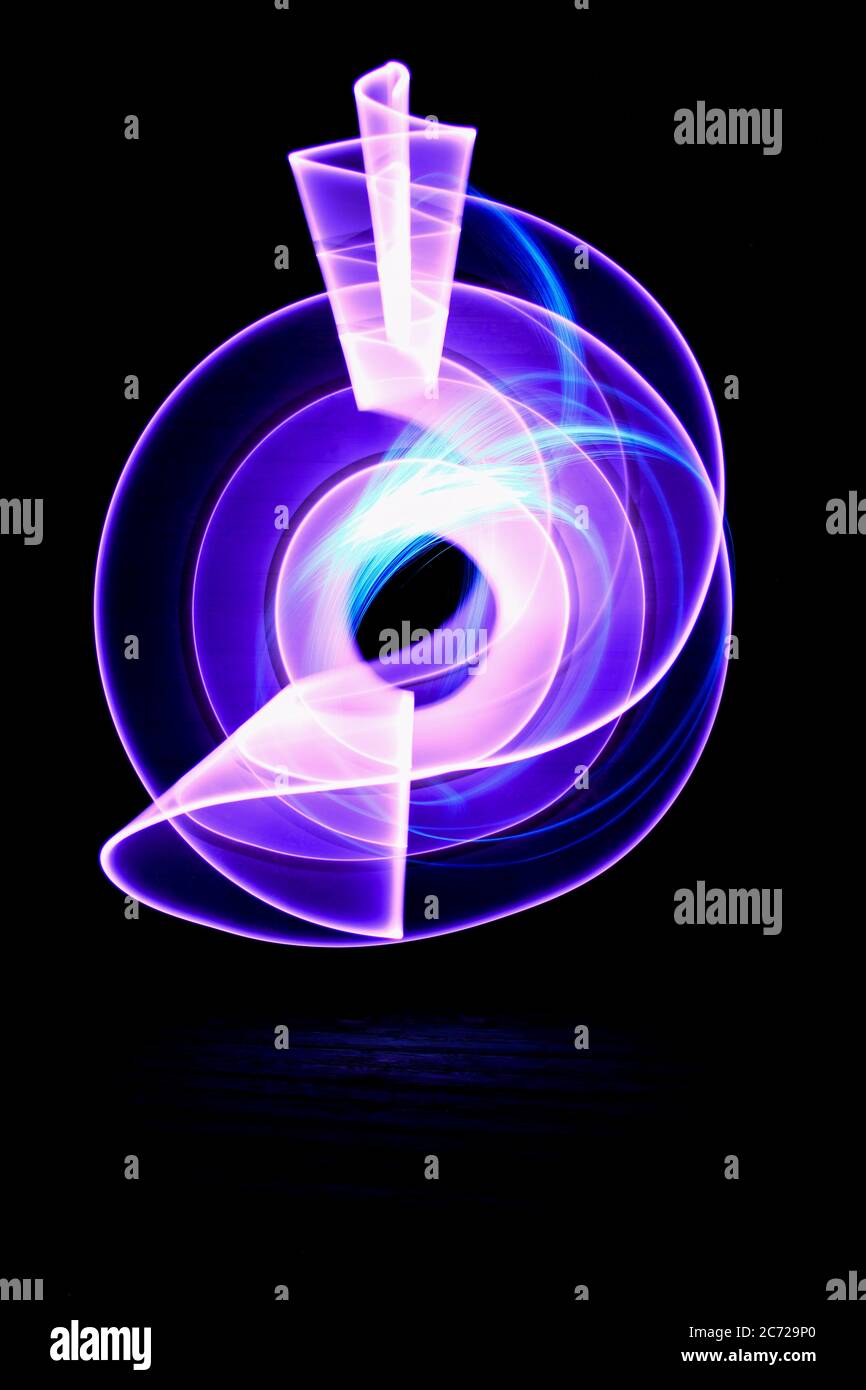 Curved abstract shape made with a light saber violet. Lightpainting ...