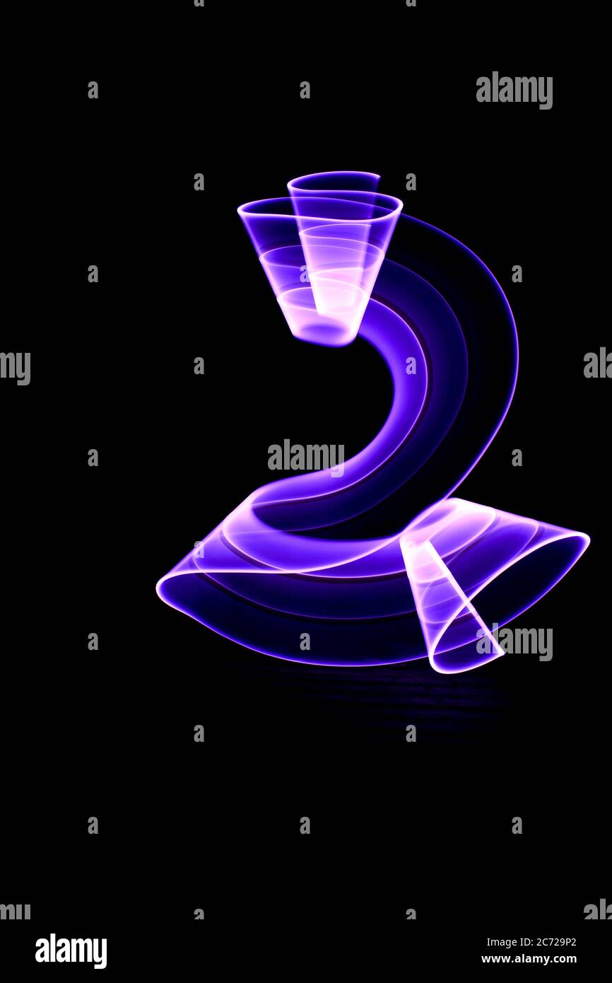 Curved abstract shape made with a light saber violet. Lightpainting ...