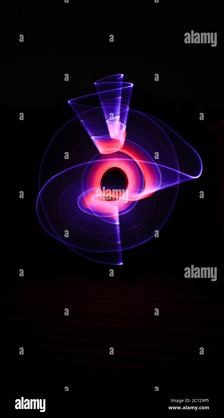Curved abstract shape made with a light saber violet. Lightpainting ...