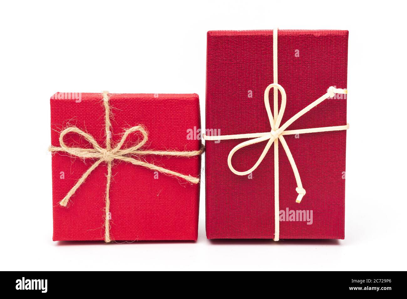 Red gift box tied with a rope tied into a bow isolated on a white ...