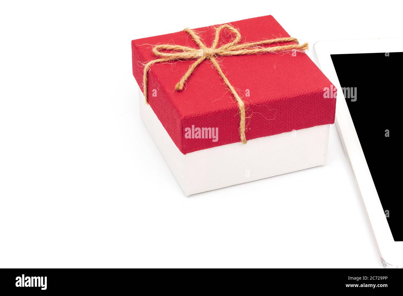 Red gift box tied with a rope tied into a bow isolated on a white ...