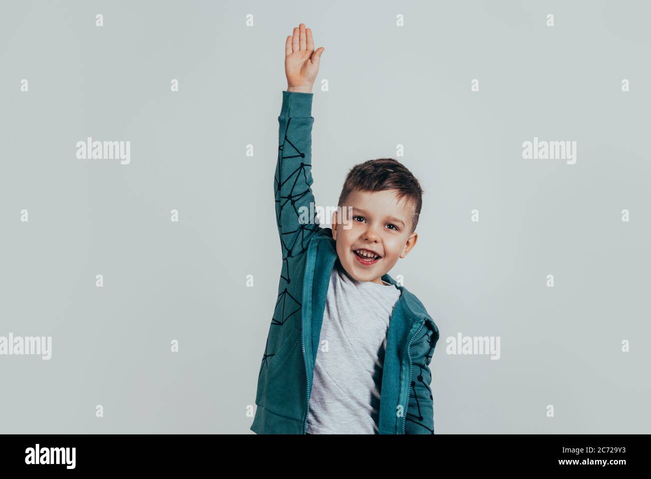 Happy child, little boy spread his hands in different directions on a ...