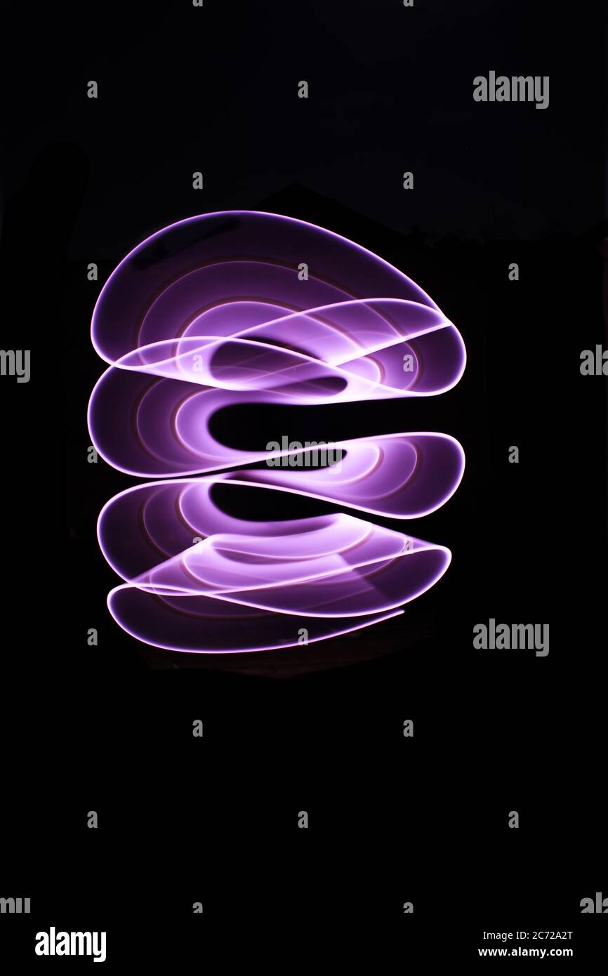 Curved abstract shape made with a light saber violet. Lightpainting ...