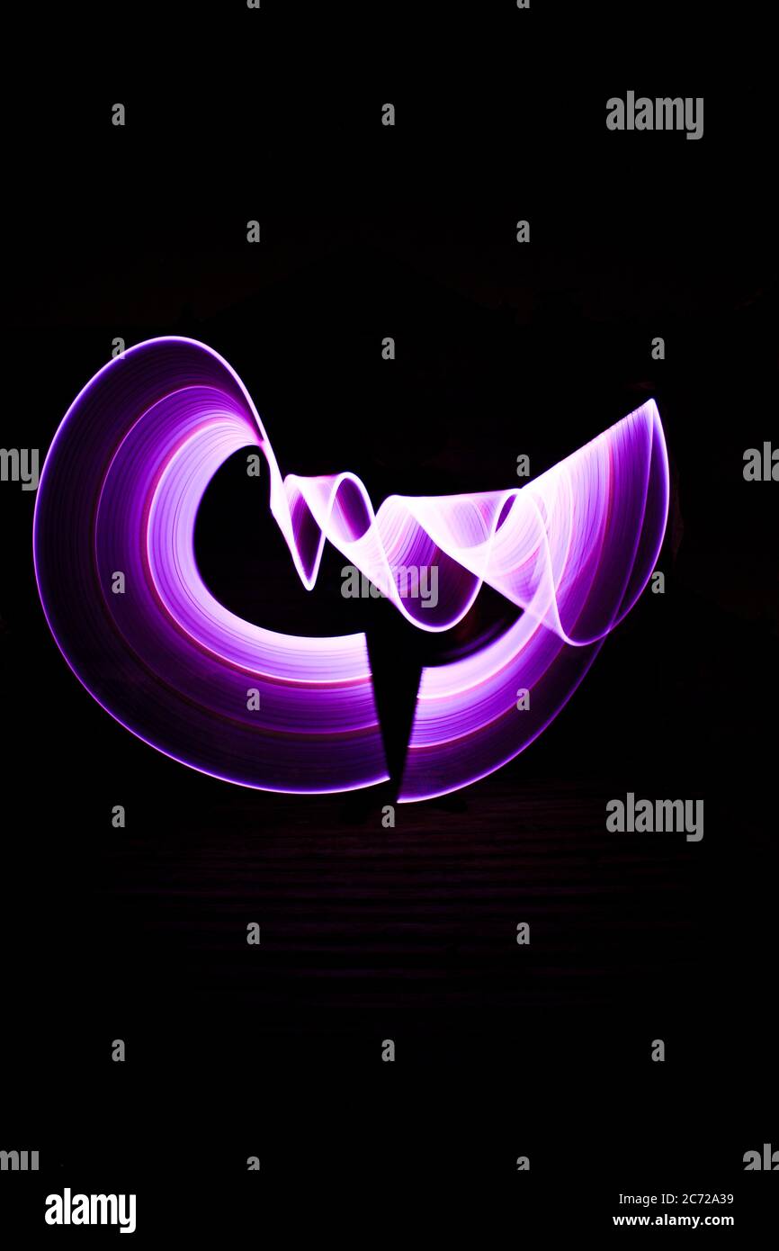 Curved abstract shape made with a light saber violet. Lightpainting ...