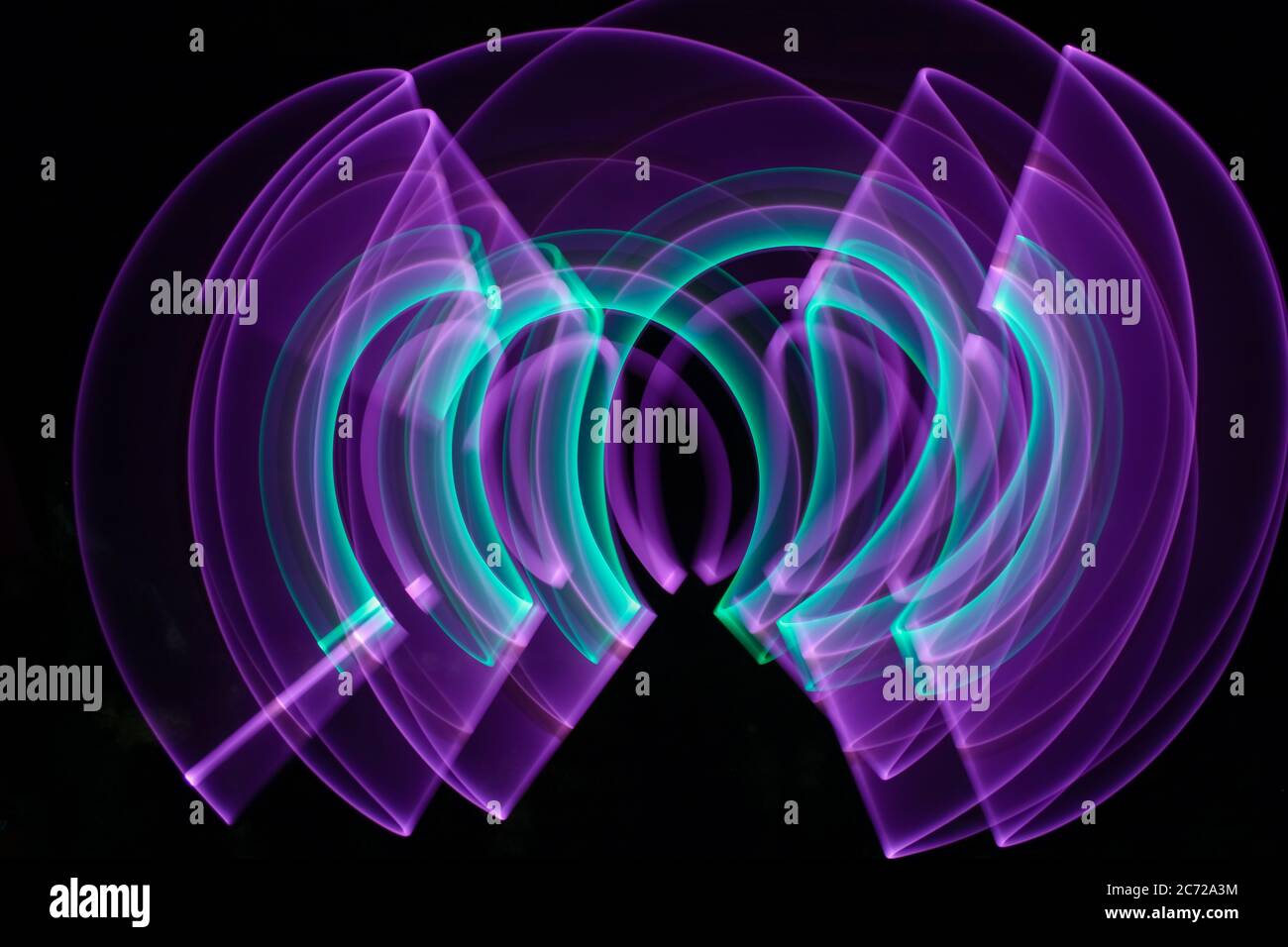 Curved abstract shape made with a light saber violet. Lightpainting ...