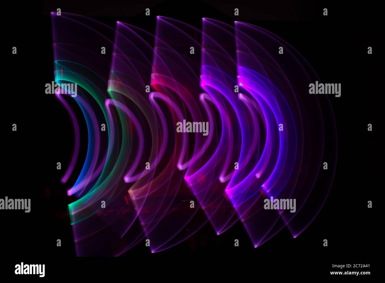 Curved abstract shape made with a light saber violet. Lightpainting ...