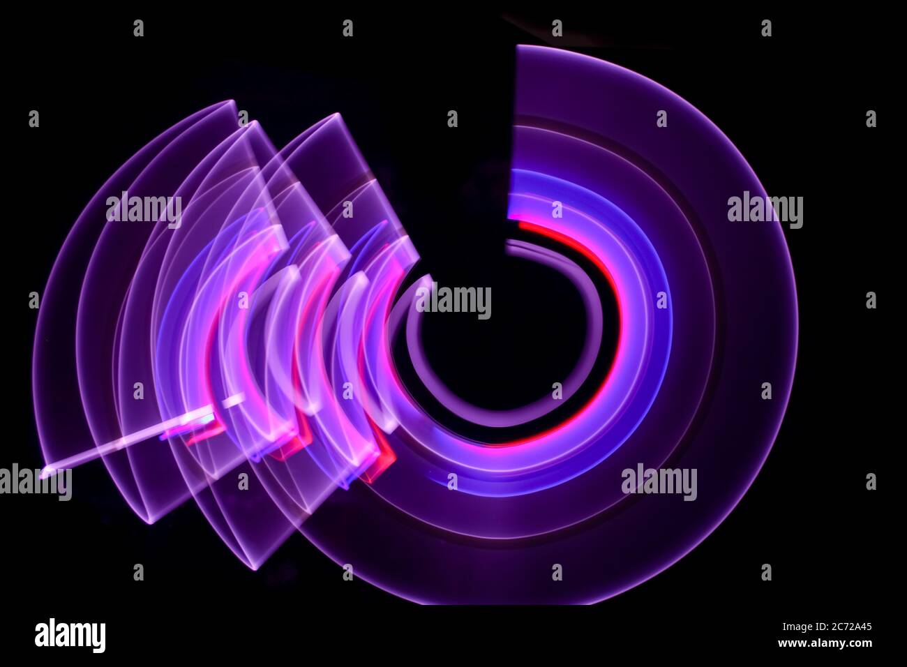 Curved abstract shape made with a light saber violet. Lightpainting ...