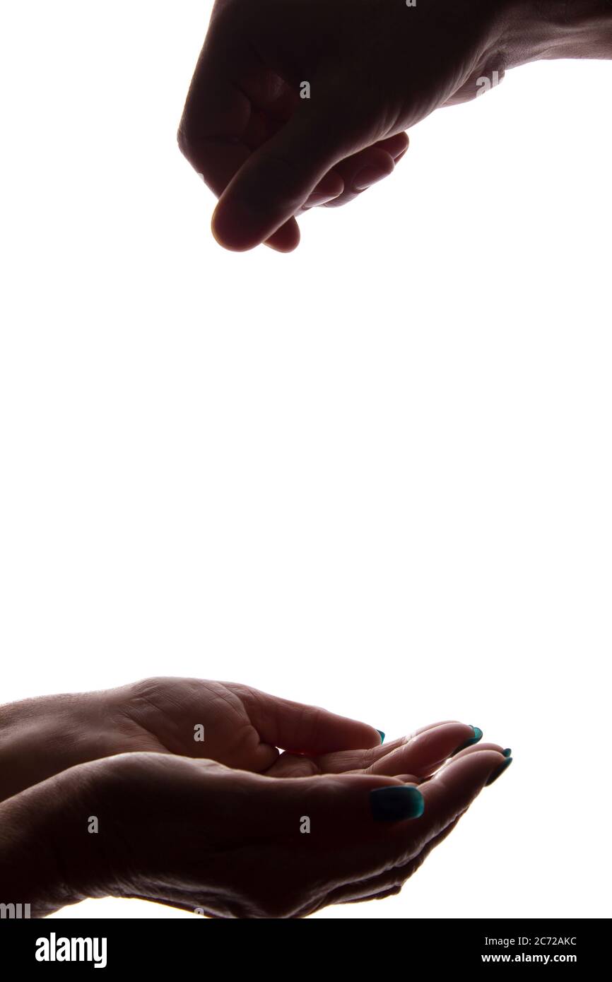 Young man's hand with a your product gives alms - silhouette, help ...