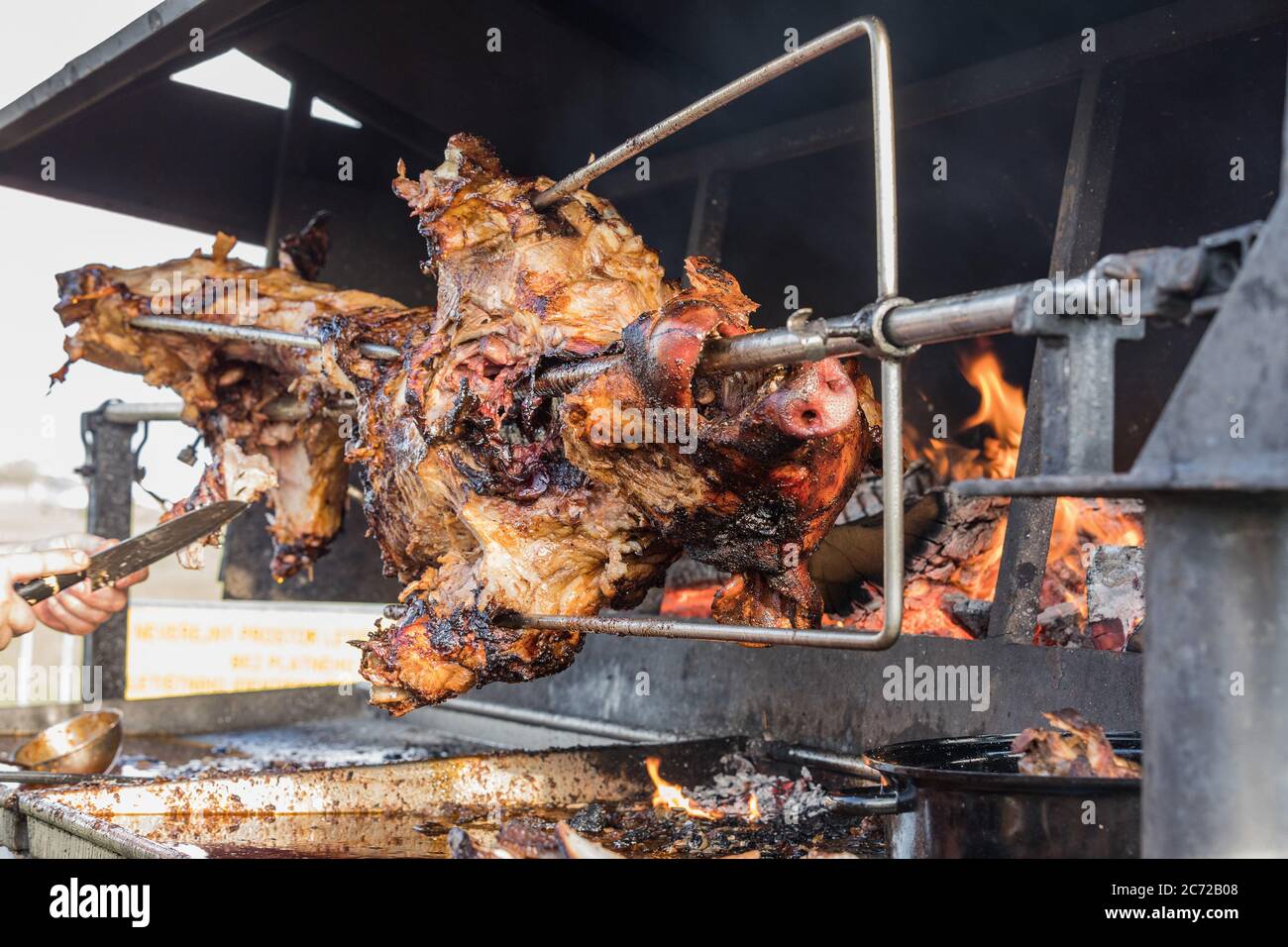A pig grilled traditional wood and fire. Pig grilled traditional coal ...