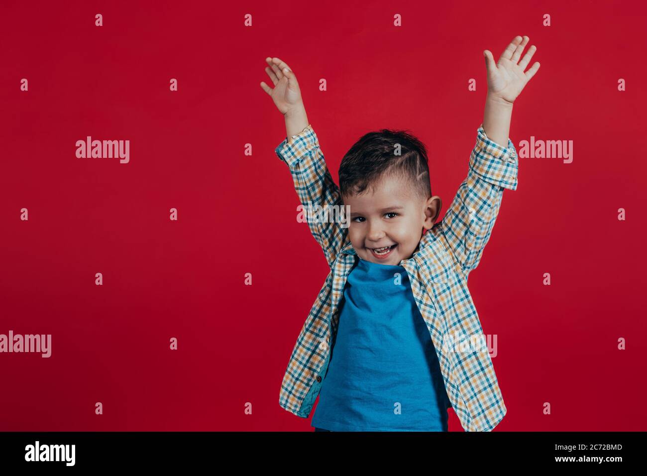 Happy child, little boy spread his hands in different directions on a ...