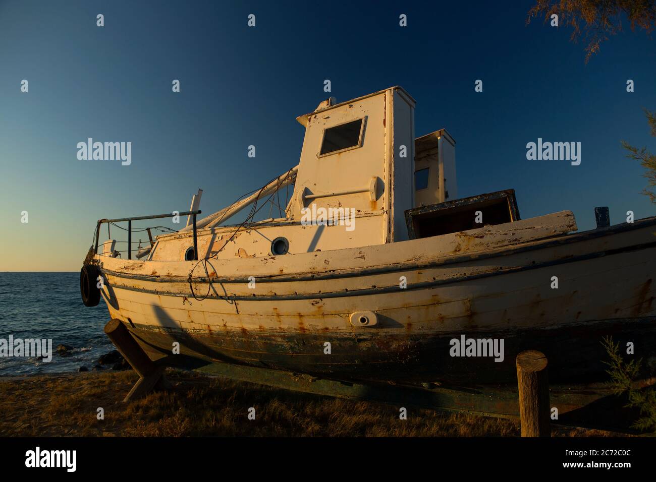 Old boat on a sea shore Stock Photo - Alamy