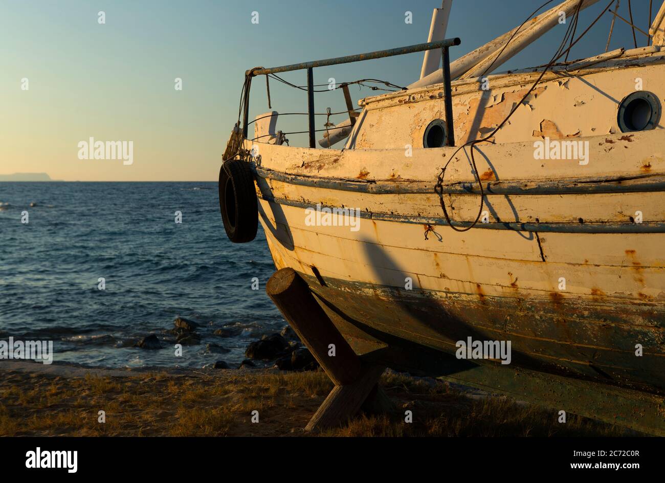 Old boat on a sea shore Stock Photo - Alamy