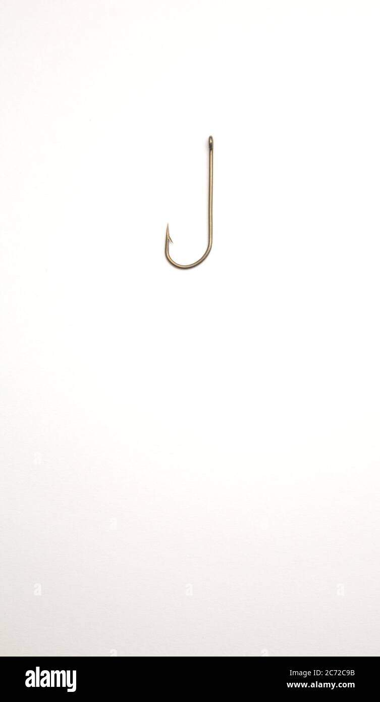 Fishing hook on a white paper background - closeup Stock Photo - Alamy