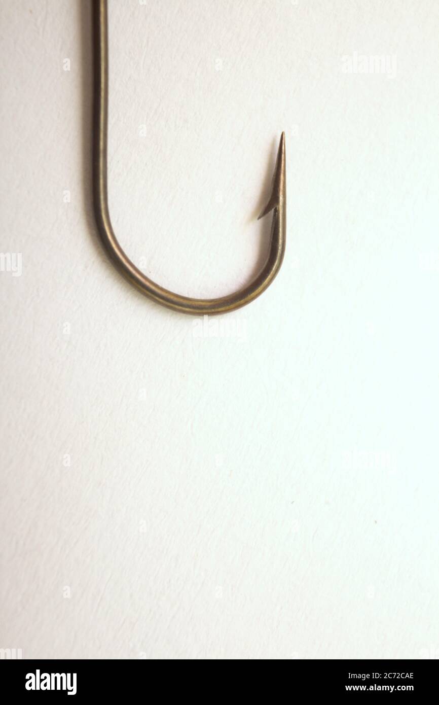 Fishing hook on a white paper background - closeup Stock Photo - Alamy