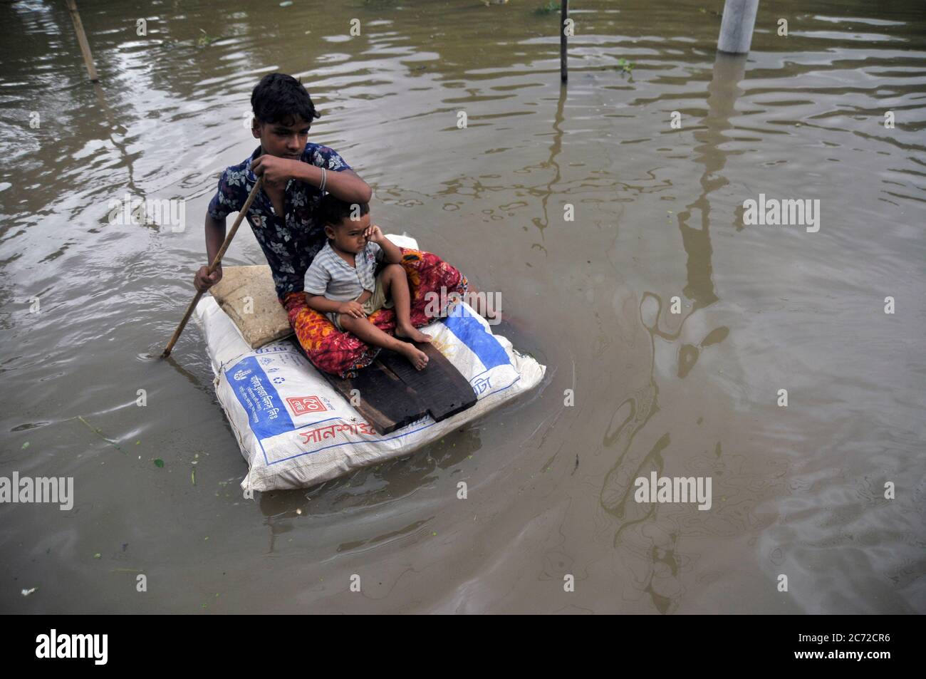 People on a handmade raft out of plastic in Sadarpar, Uposhahar. The ...