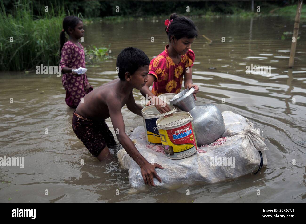 Children are going to collect drinking water on a handmade raft out of ...