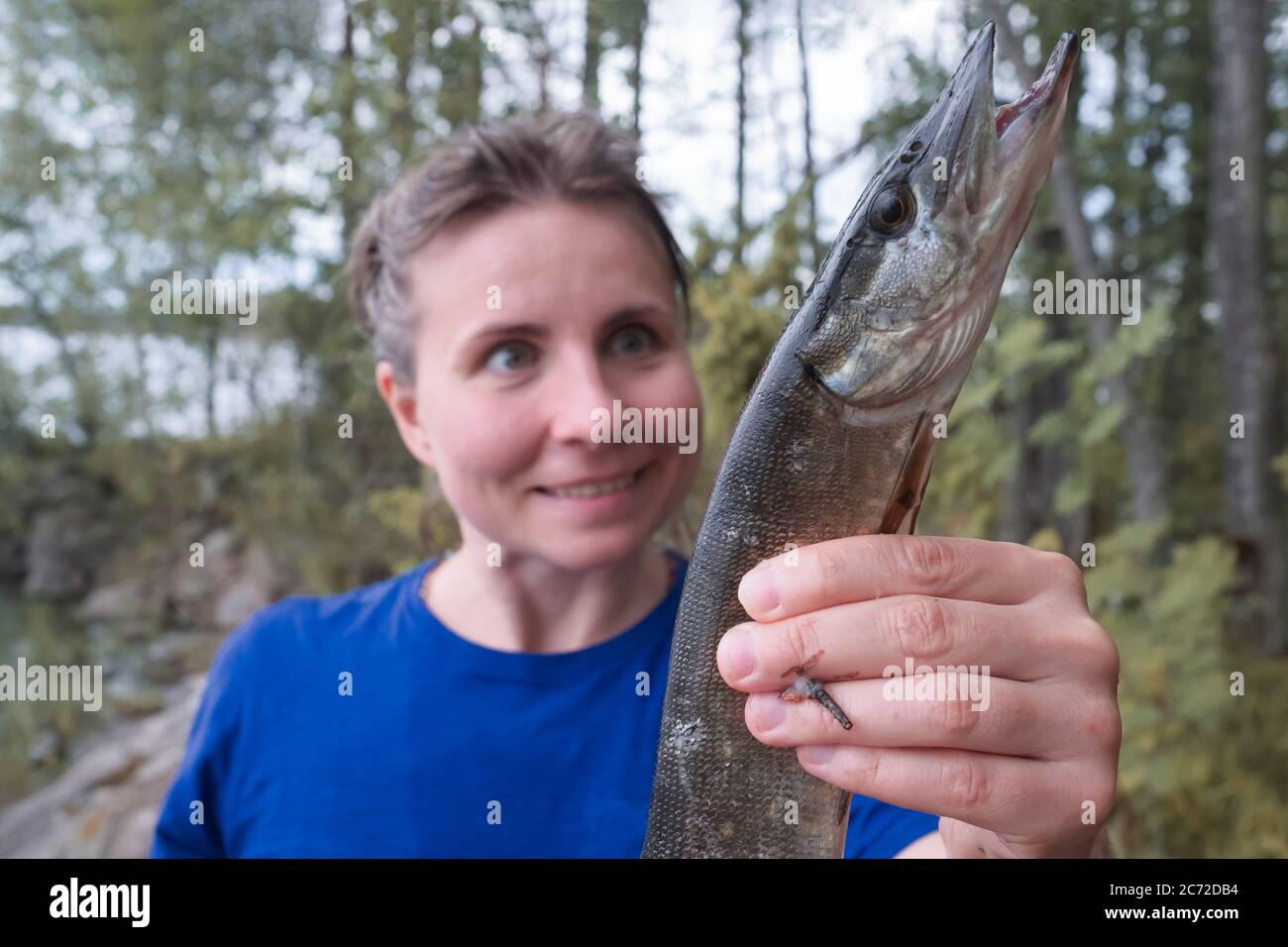 Young excited woman fishing a pike outdoor Stock Photo - Alamy