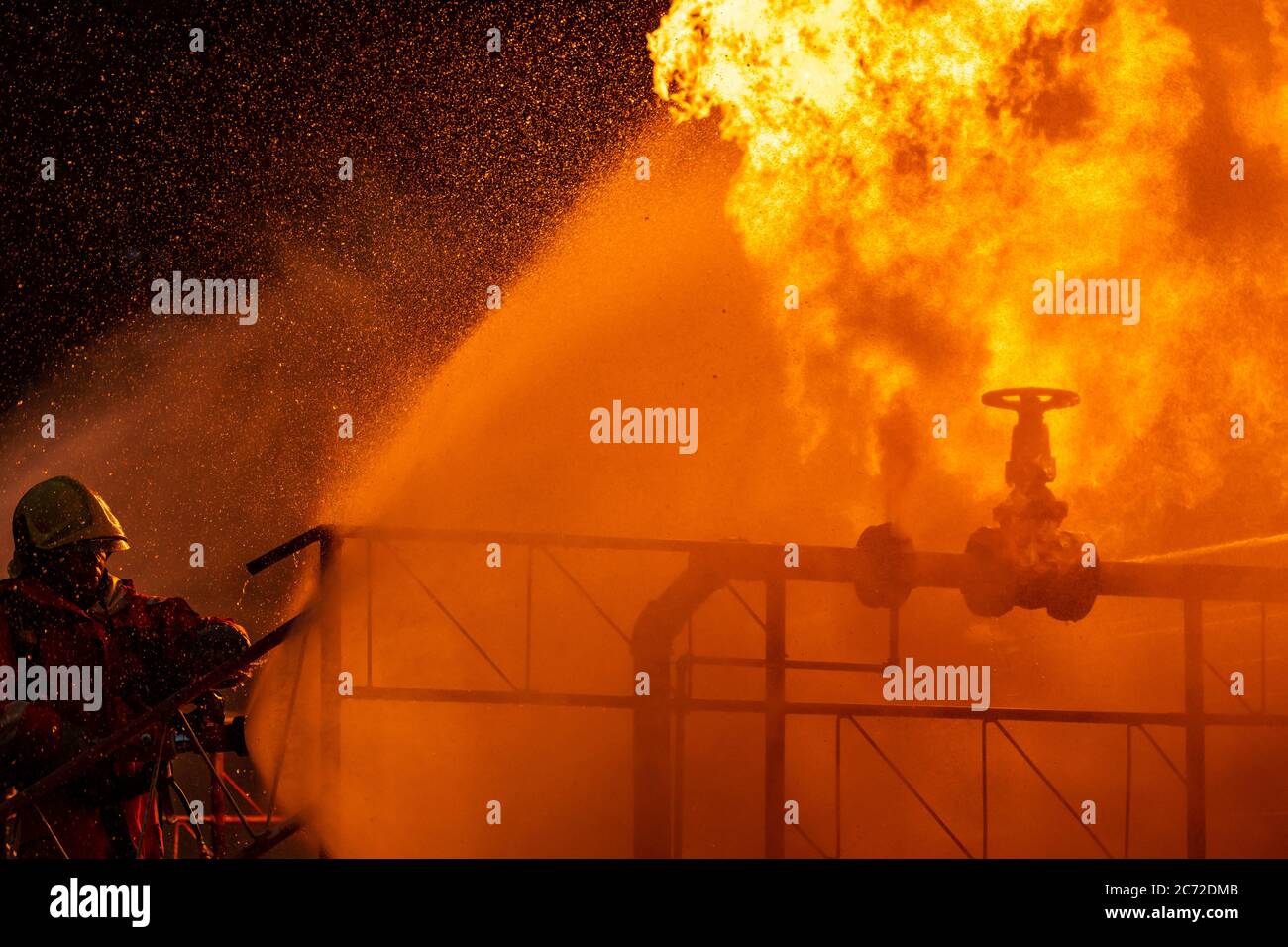 Firefighter using water fog type fire extinguisher to fighting with the ...