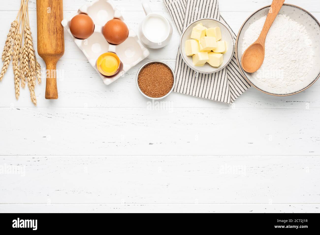 Ingredients for baking on white wooden table background. Cooking ...