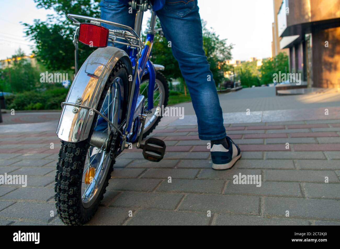The boy is ready to ride a bike on the street of the city Stock Photo ...