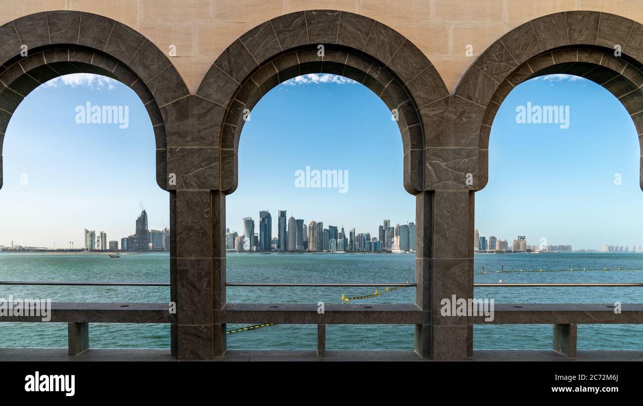 Doha, Qatar - February 2019: Doha skyline through the arches of the ...