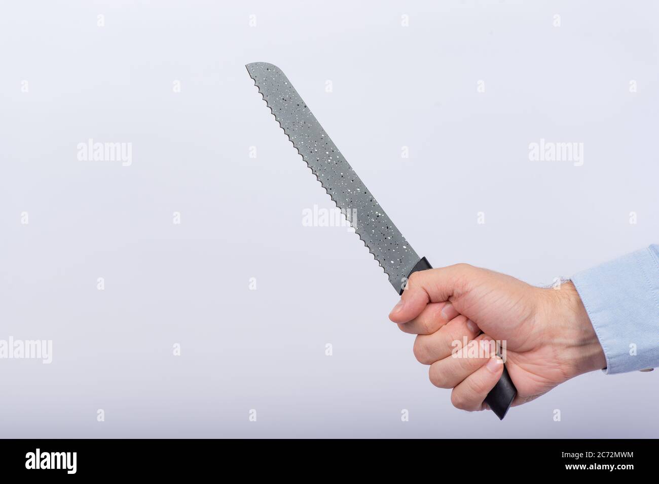 Male hand holding hacksaw on white background. Hand saw in hand. Close ...