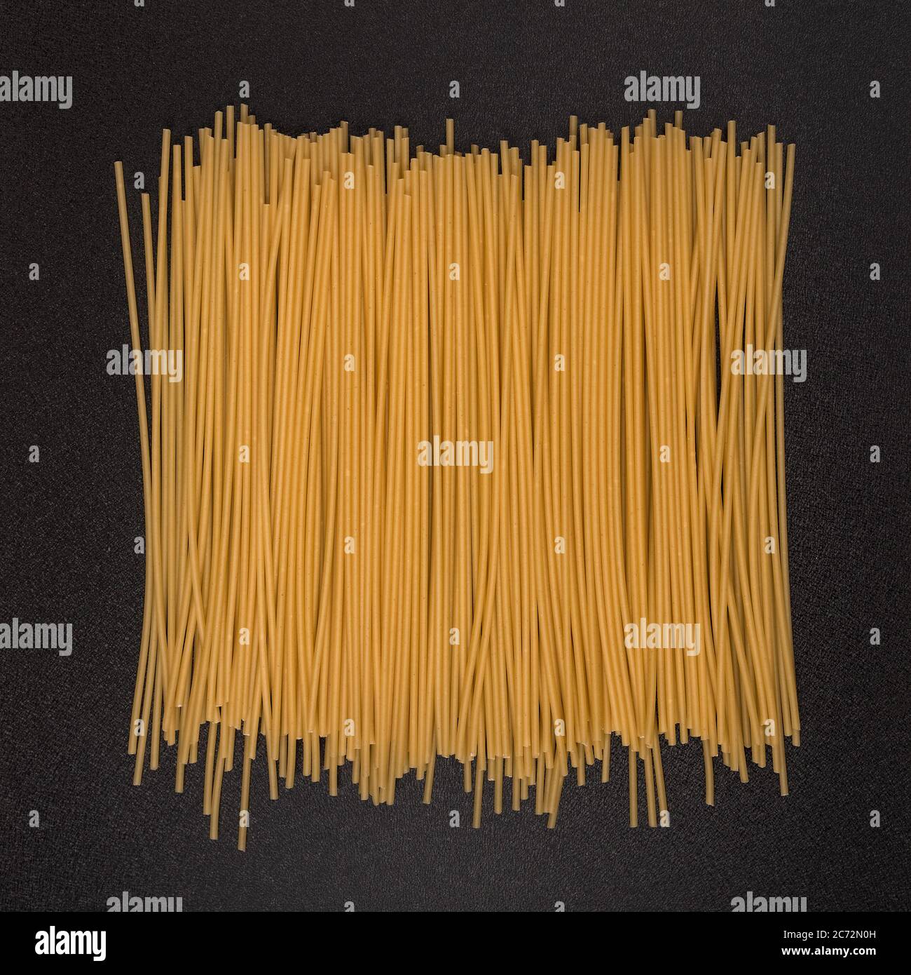 Spaghetti from durum wheat on black background. Italian raw pasta Stock ...
