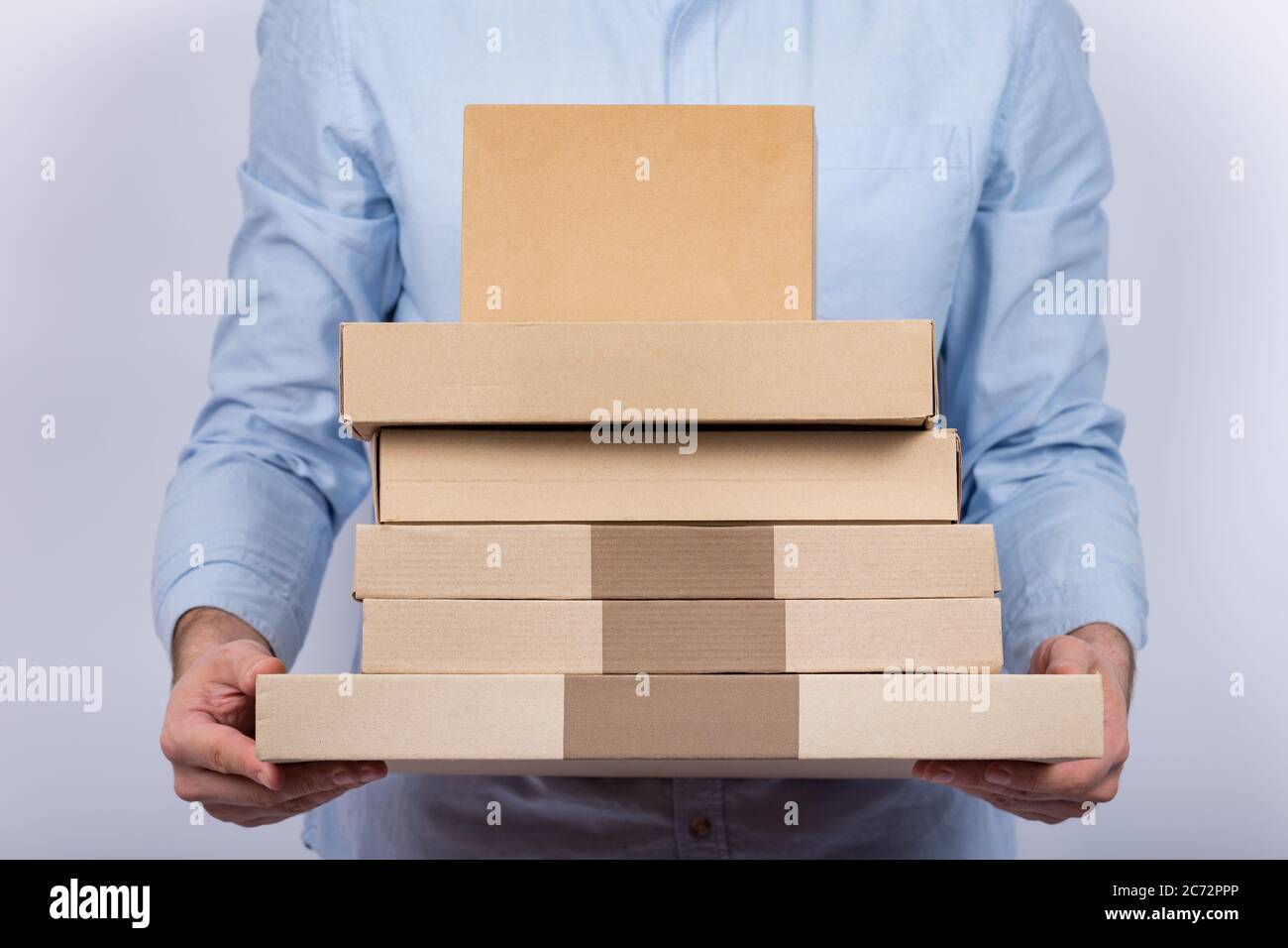 man keep a lot of cardboard boxes. Express delivery concept. Delivery ...