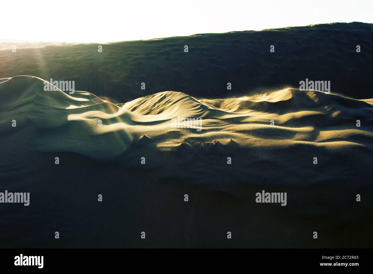 Singing barchan or buzzing dune. The wind blows thin sand from crest of ...